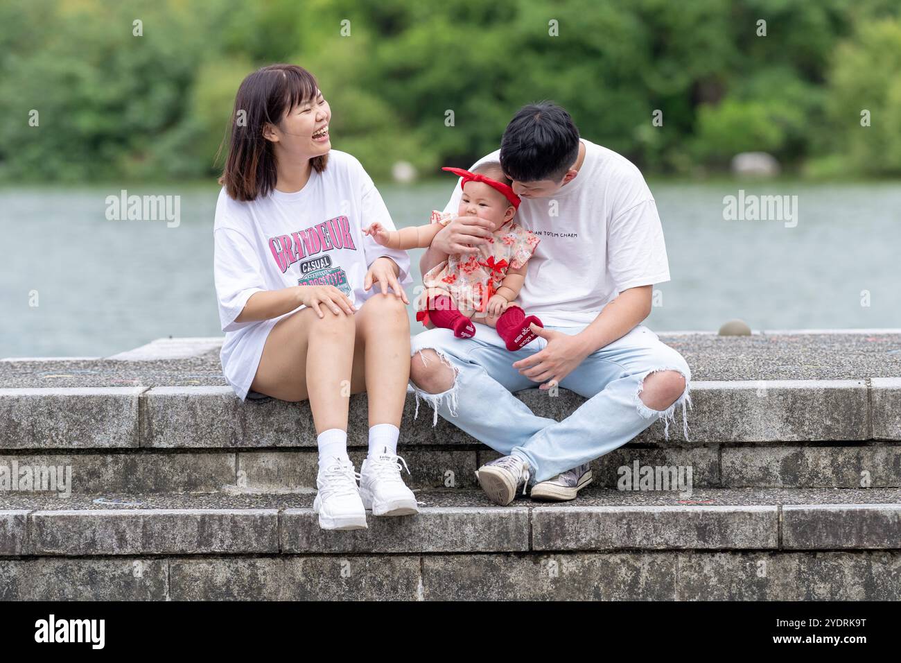 A Taiwanese couple in their 20s and their 7-month-old baby celebrate a ...