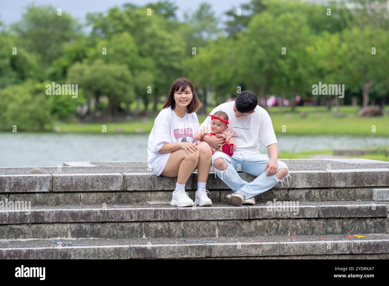 A Taiwanese couple in their 20s and their 7-month-old baby celebrate a ...
