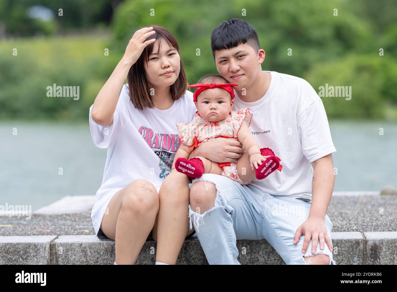 A Taiwanese couple in their 20s and their 7-month-old baby celebrate a ...