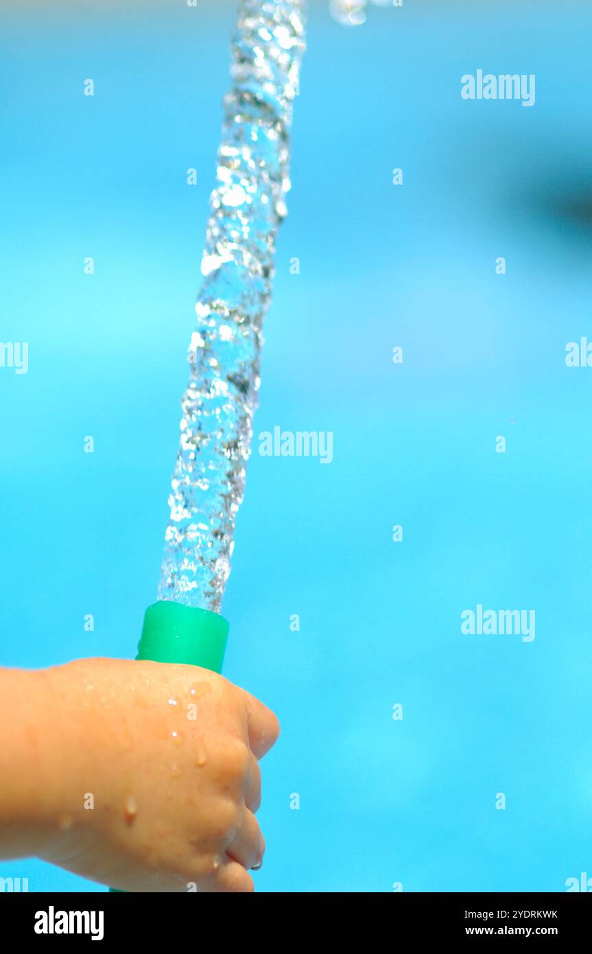 Hand holding rubber hose Stock Photo - Alamy