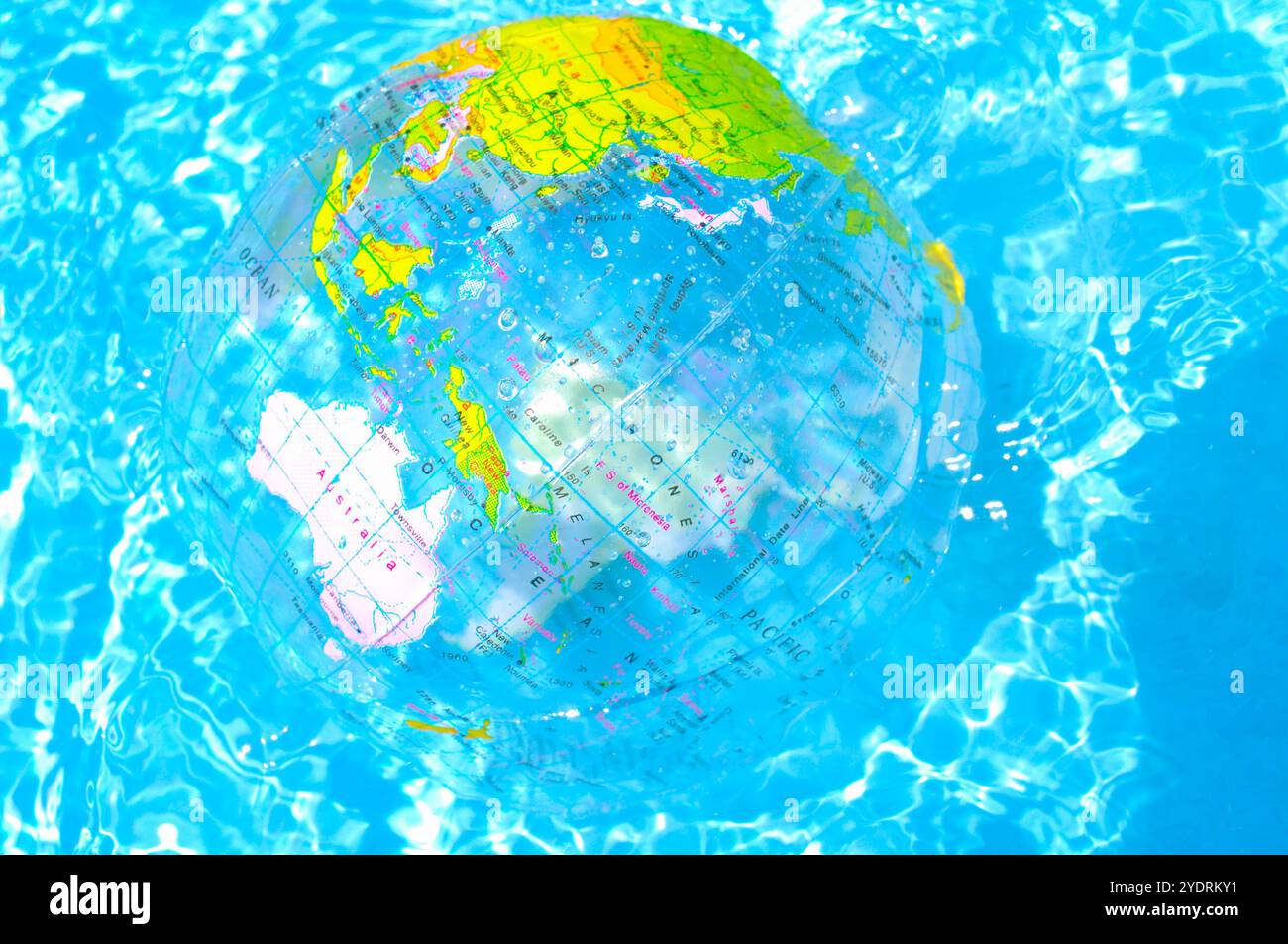 Earth-shaped beach ball floating on the surface of the water Stock ...