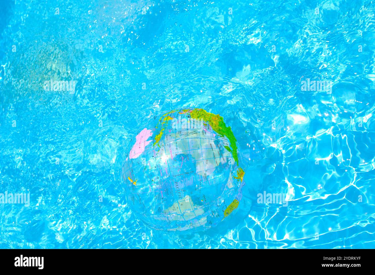 Earth-shaped beach ball floating on the surface of the water Stock ...