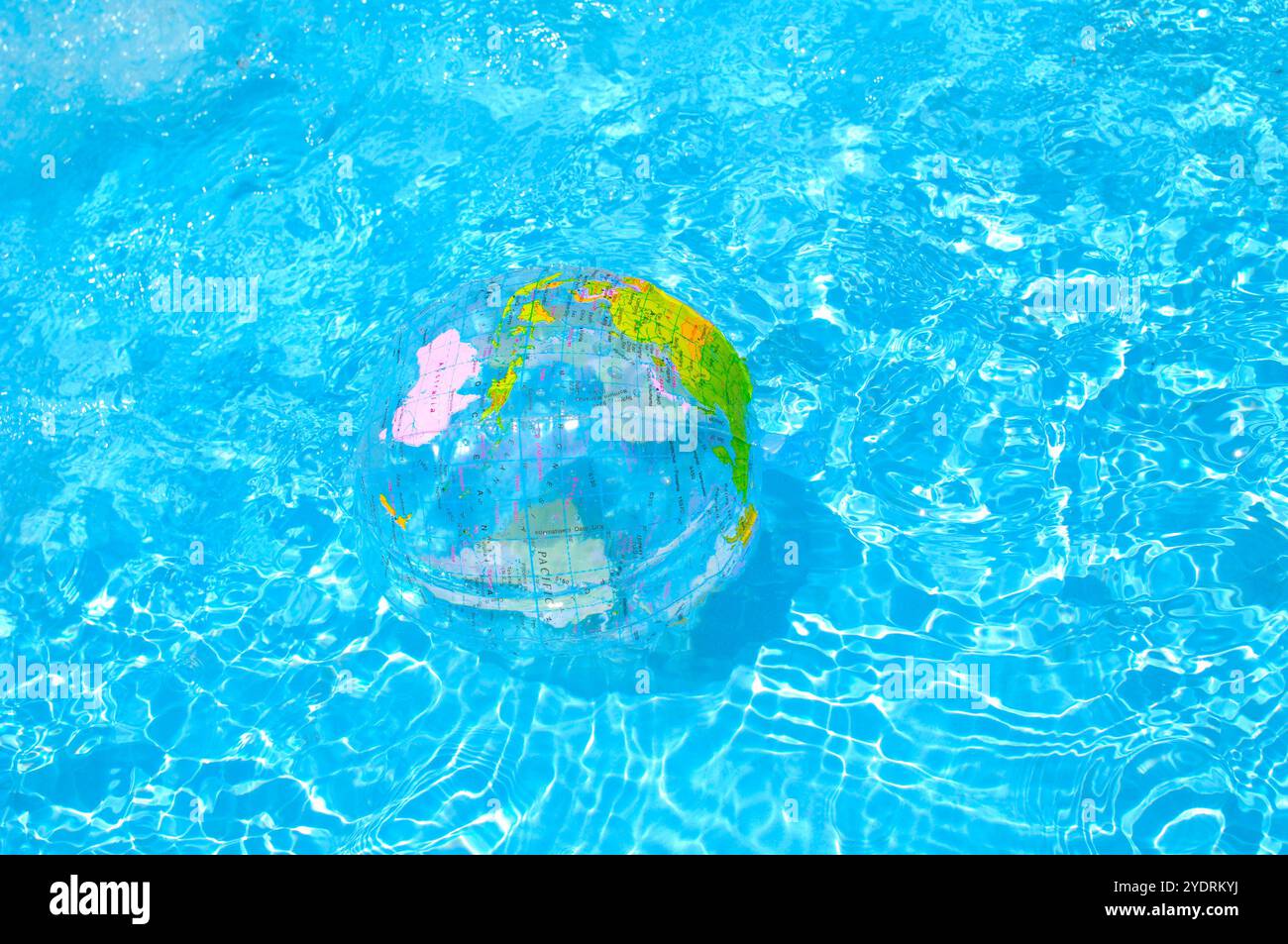 Earth-shaped beach ball floating on the surface of the water Stock ...
