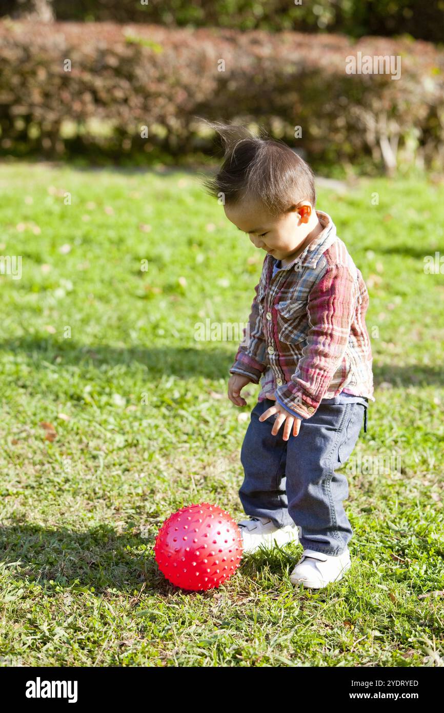 Little boy and red ball Stock Photo - Alamy