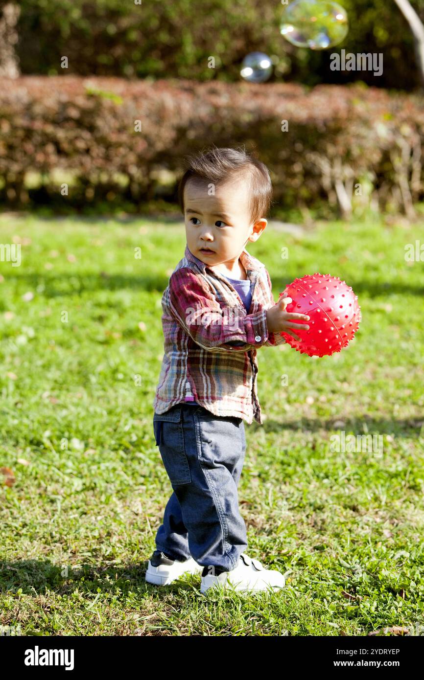 Little boy and red ball Stock Photo - Alamy