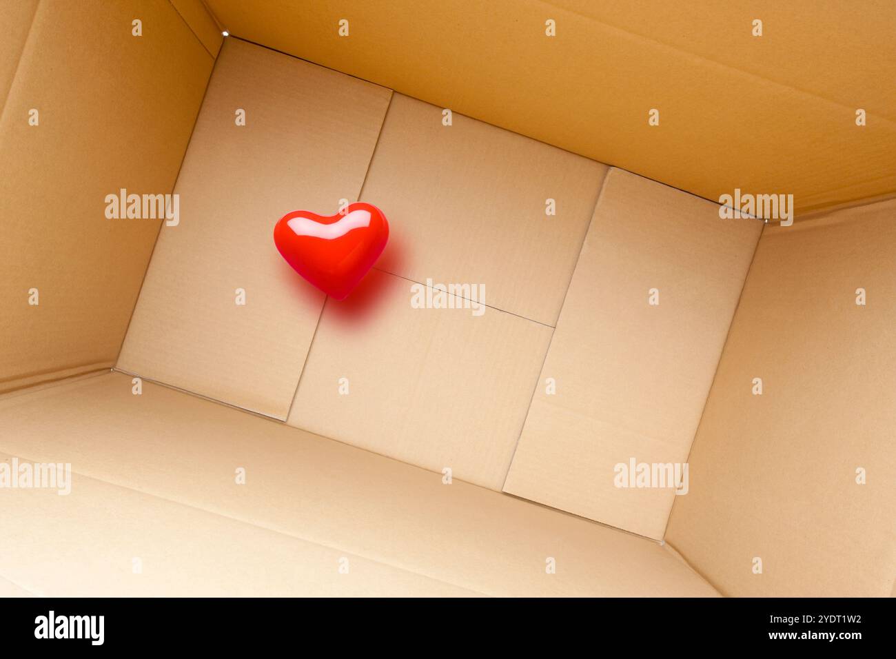 Heart inside cardboard Stock Photo - Alamy