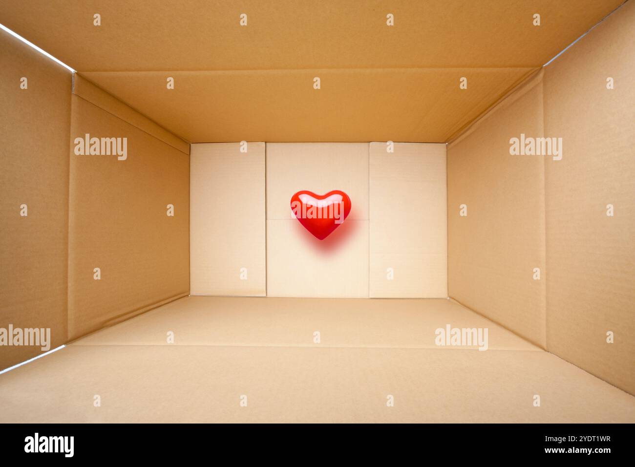 Heart inside cardboard Stock Photo - Alamy