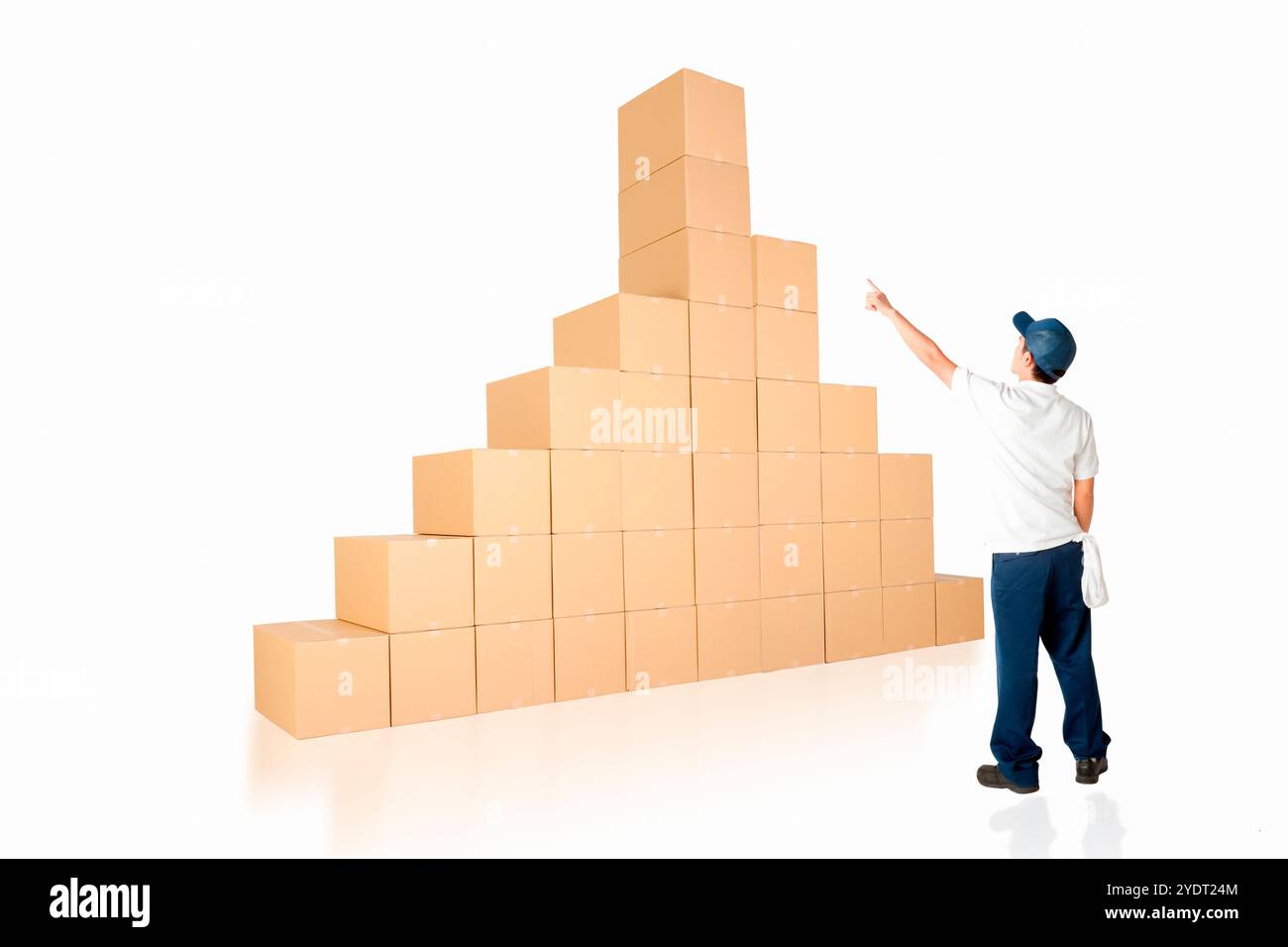 Worker pointing to a stack of cardboard boxes Stock Photo - Alamy