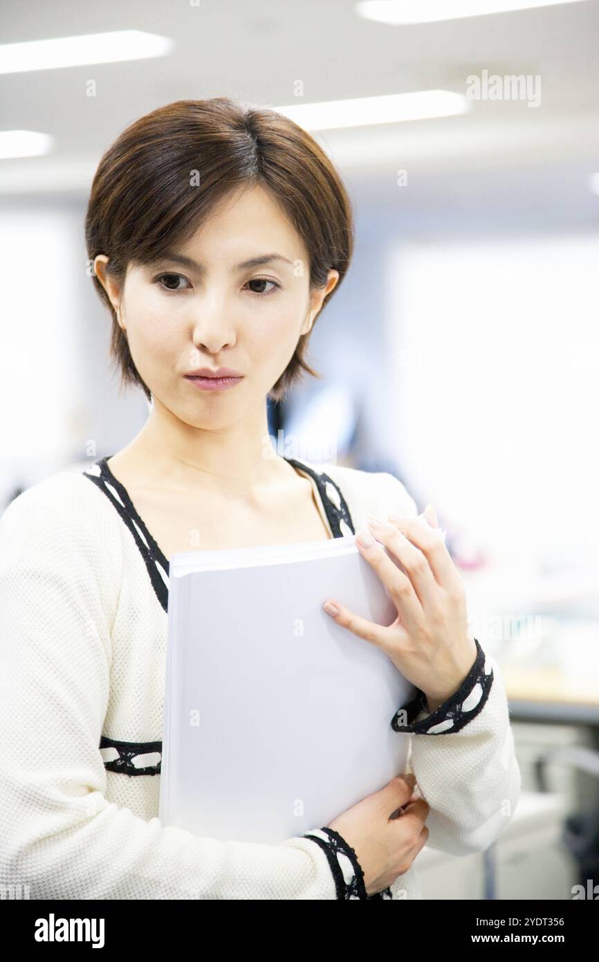 Office worker holding photocopy paper Stock Photo - Alamy