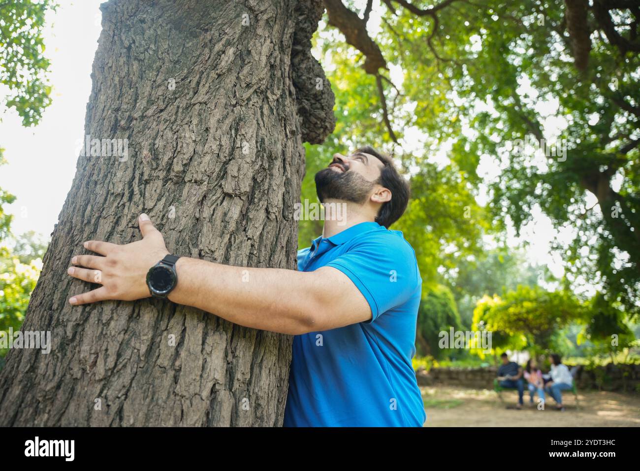 young indian man embracing large tree, Save planet, ecology, climate ...