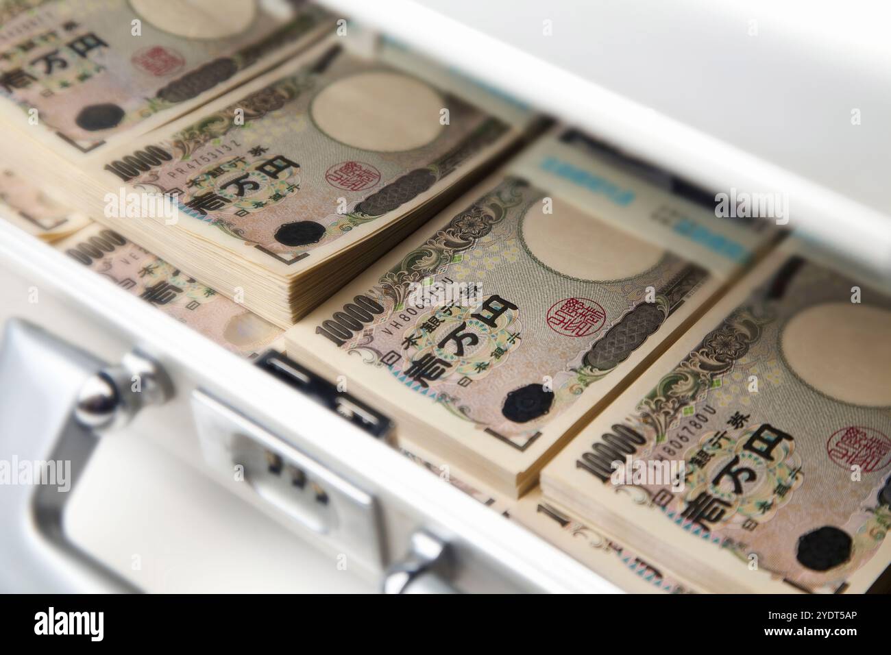 Attache case and wad of notes Stock Photo - Alamy