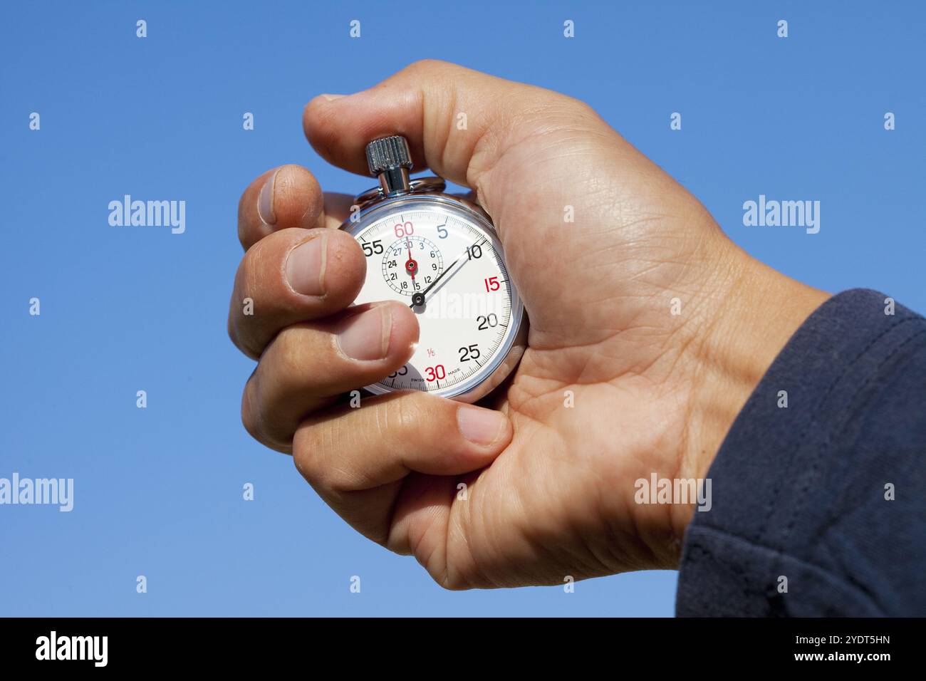 Hand holding stopwatch Stock Photo - Alamy