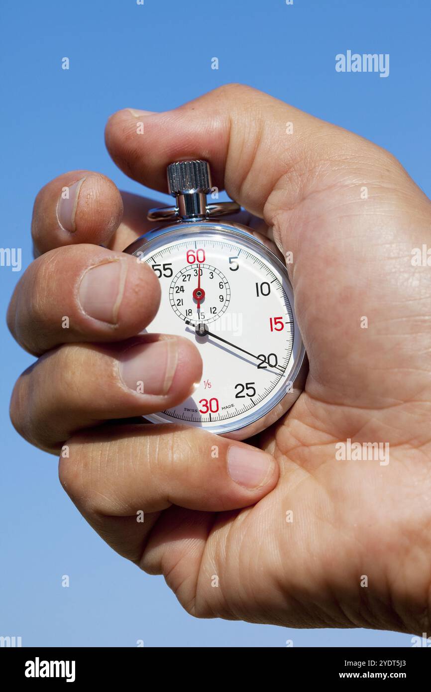 Hand holding stopwatch Stock Photo - Alamy