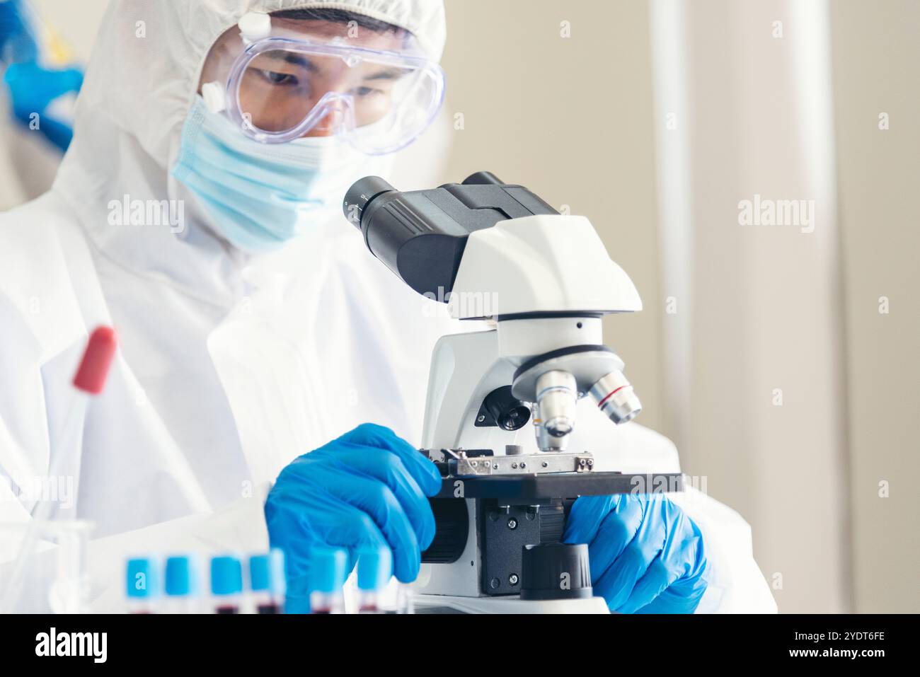 Male Scientist look into Microscope research in science laboratory ...