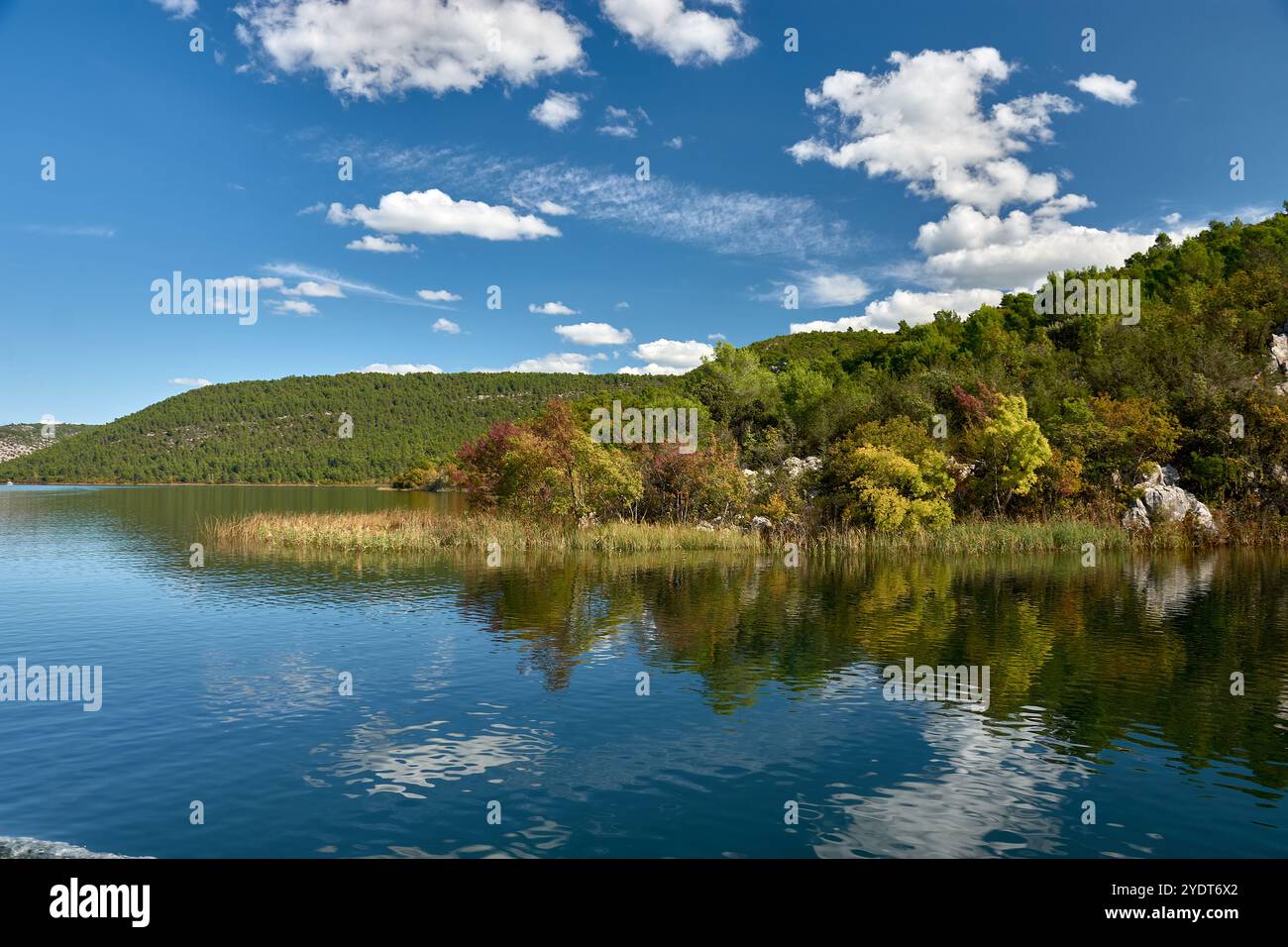 A peaceful boat ride through Krka National Park in Croatia. The wake of ...