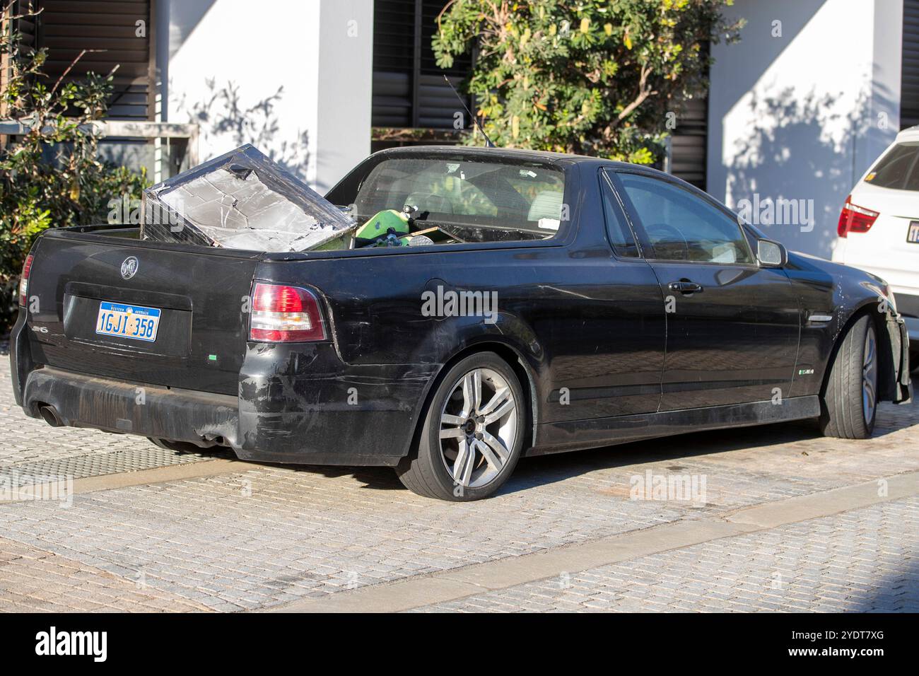 A black Holden ute utility vehicle parked on a cobblestone street ...