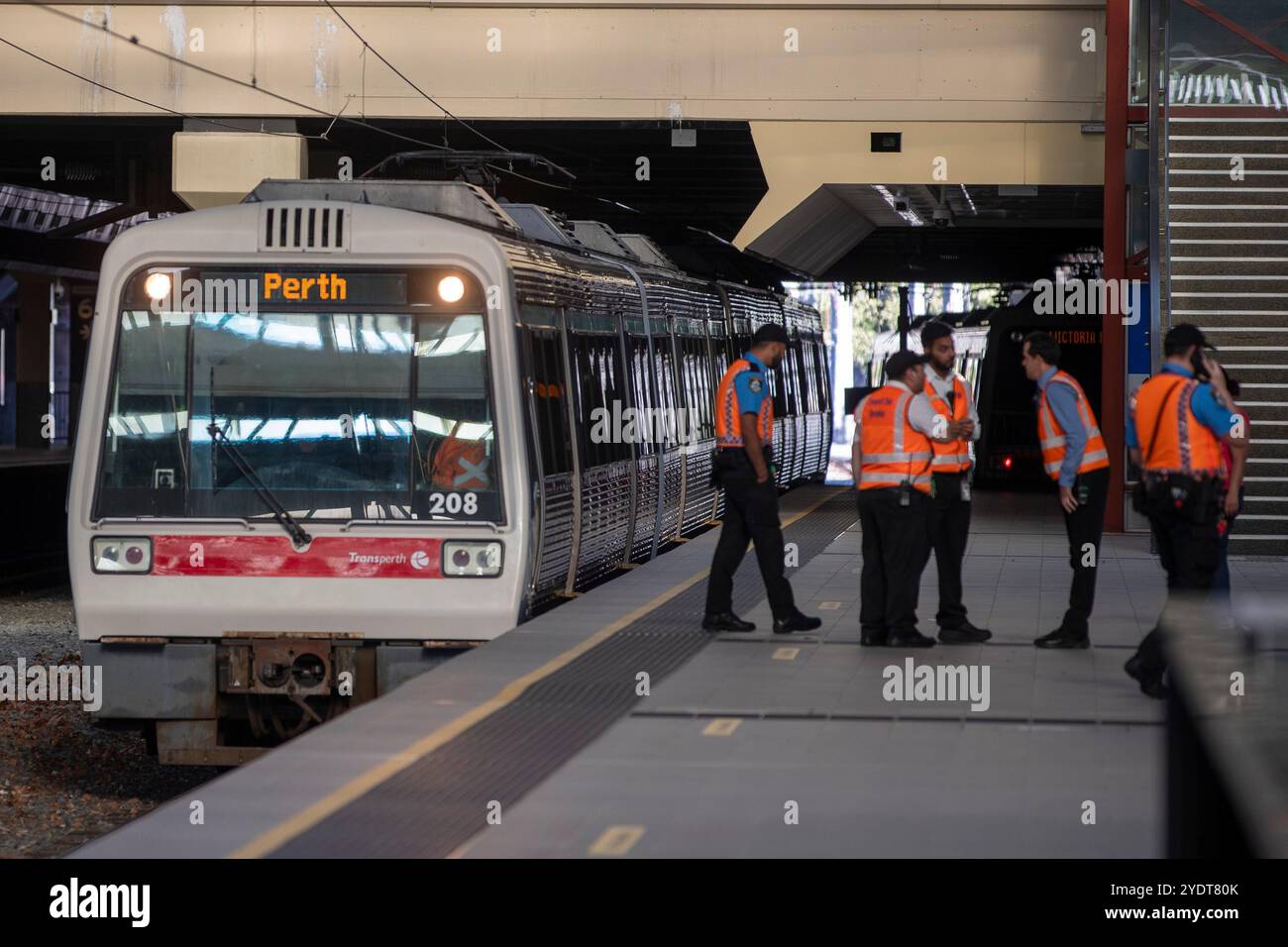 A Transperth train stationed at a platform in Perth, with several ...