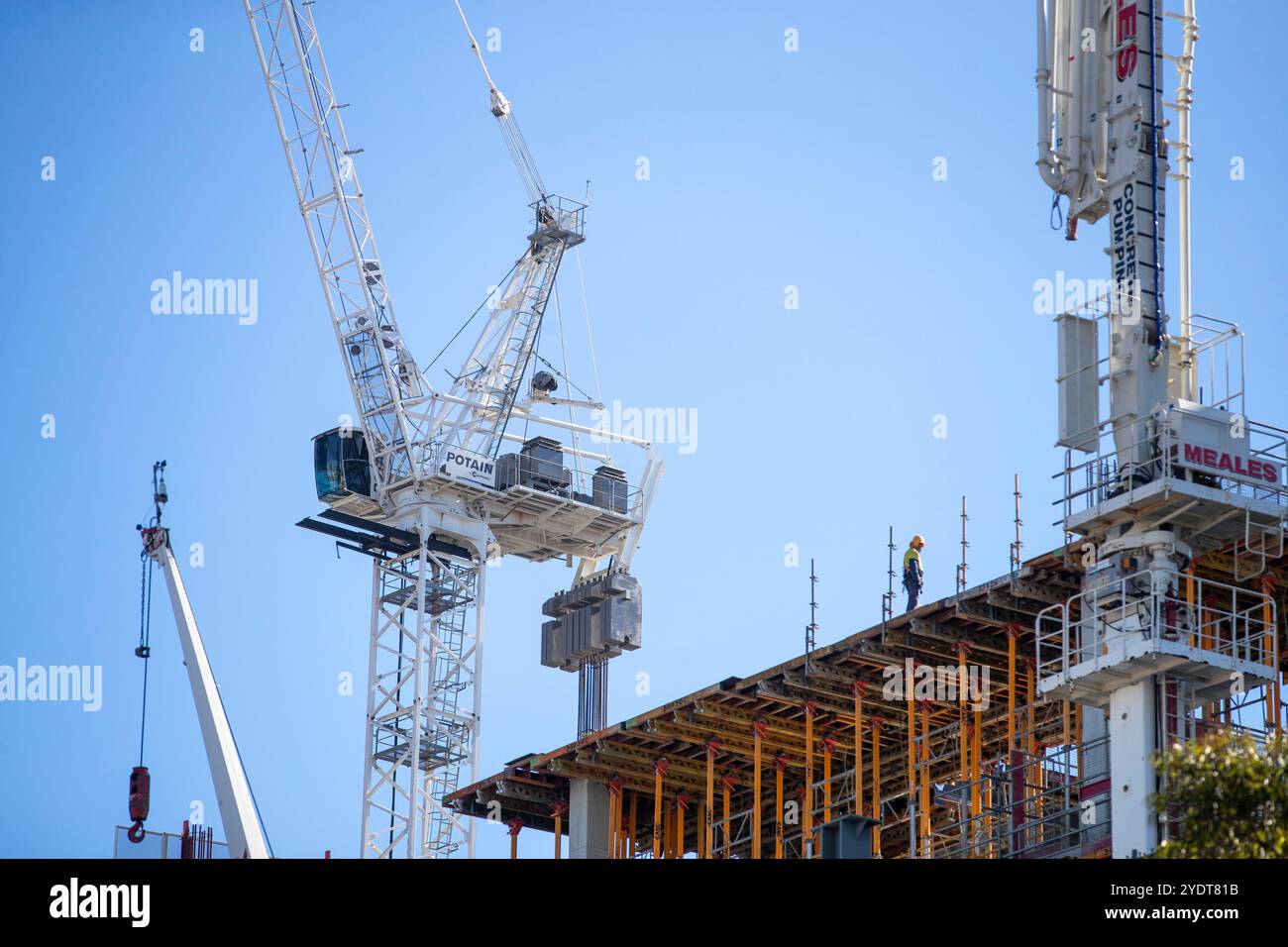 construction site featuring multiple cranes labeled "Potain" and ...