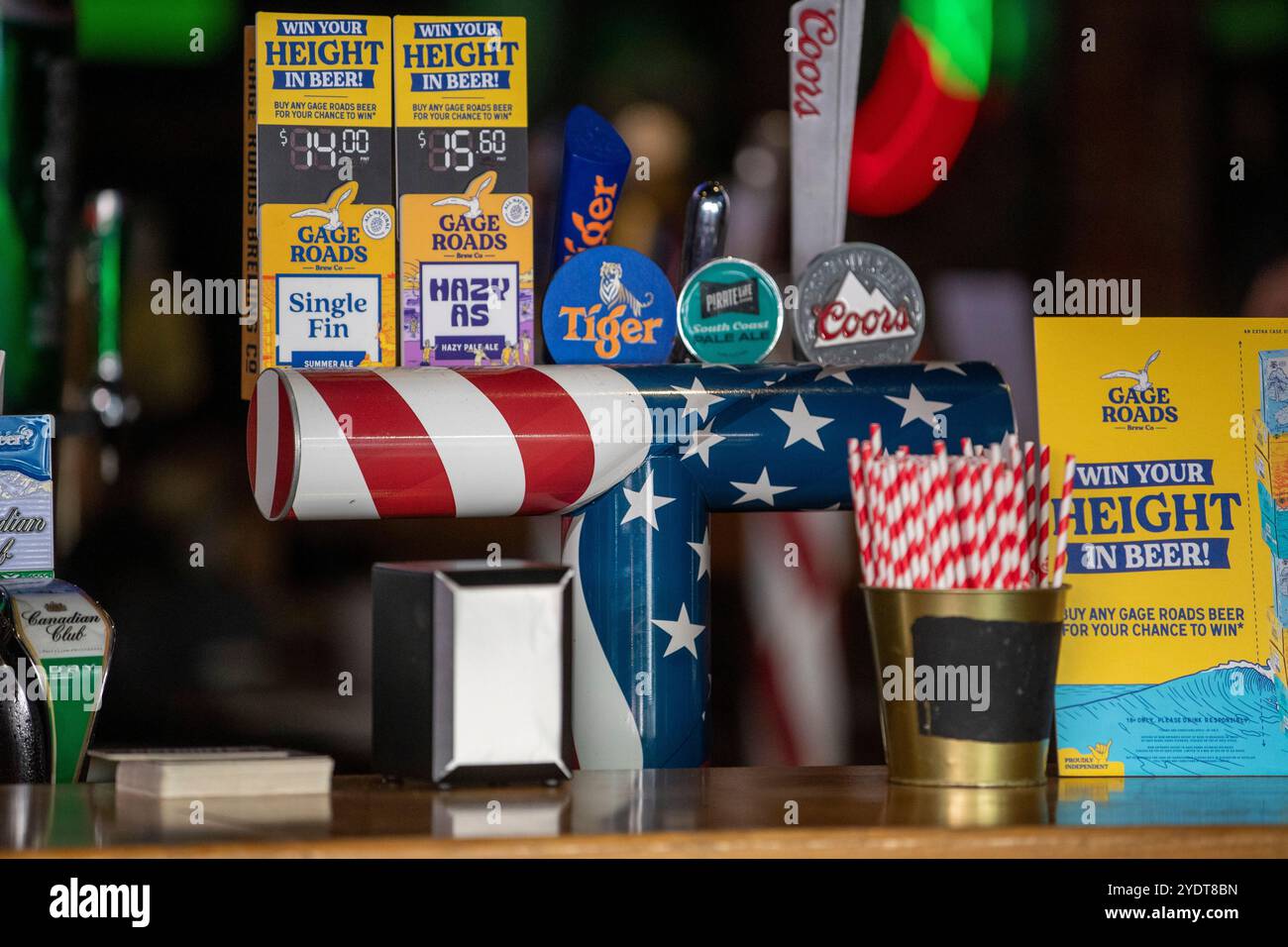 A close-up of a bar counter with beer taps featuring Gage Roads, Tiger ...