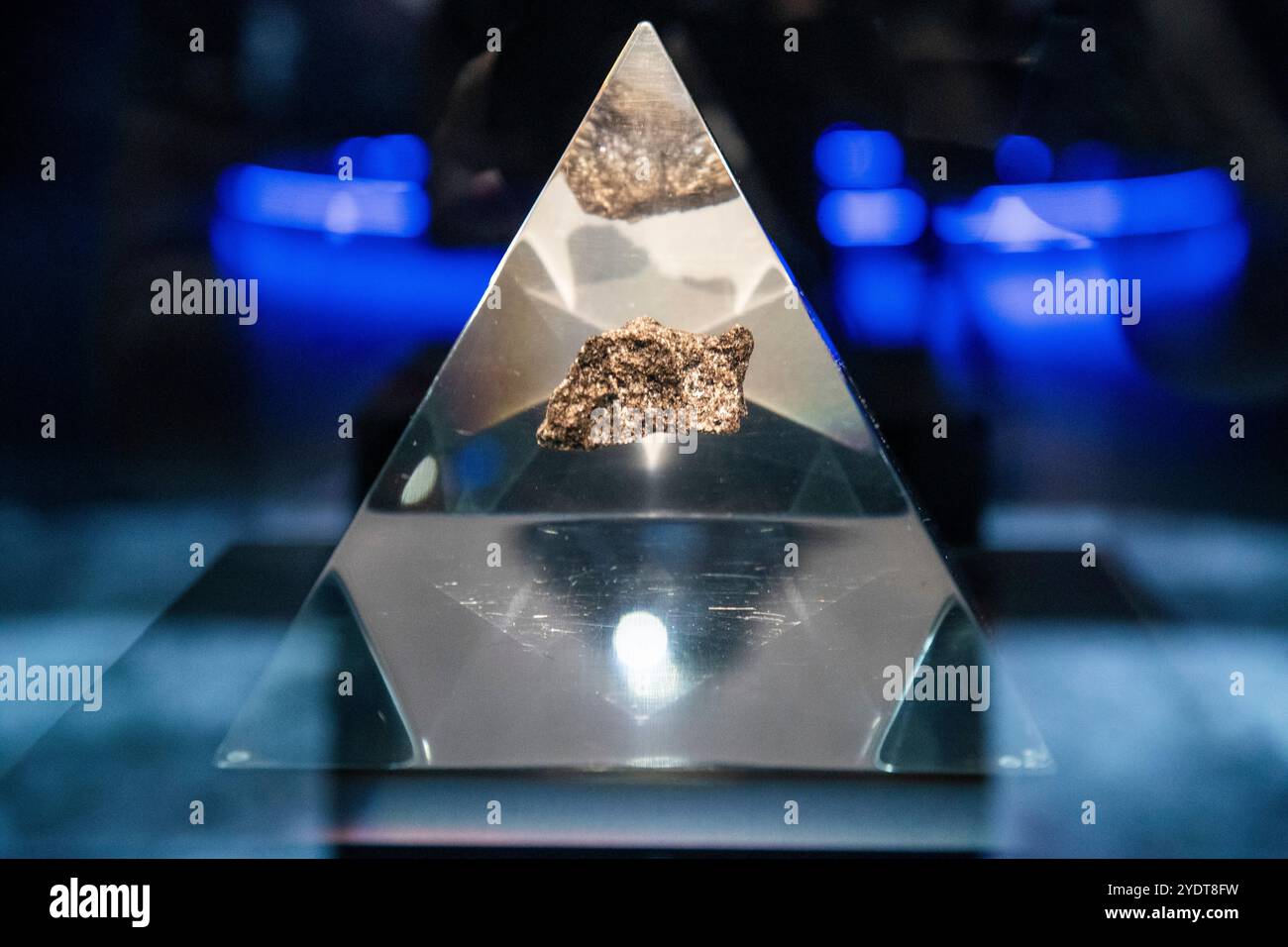 A fragment of a meteorite displayed in a transparent pyramid-shaped ...