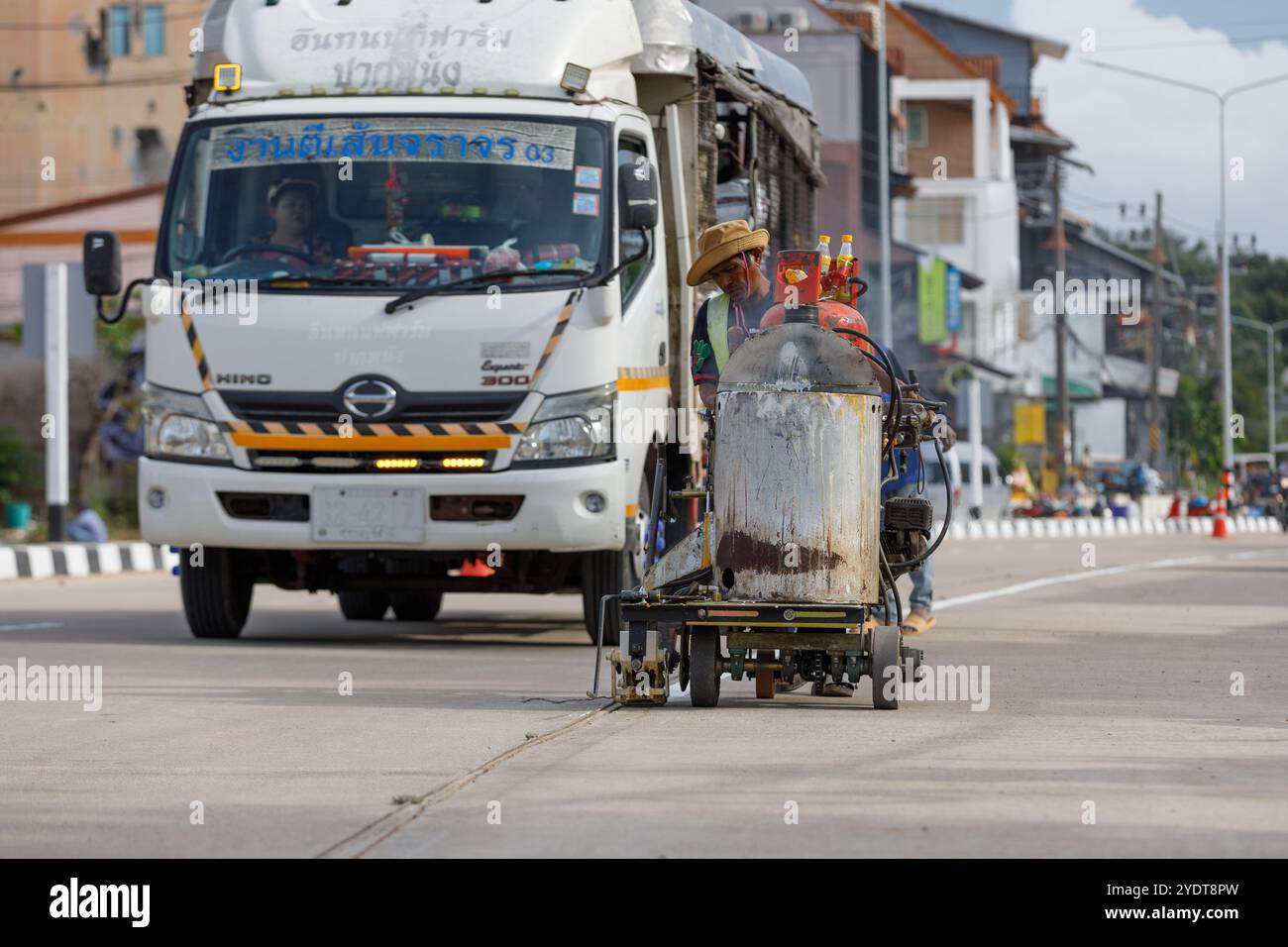 Hot melt road line marking. Painting white lines on a concrete road ...