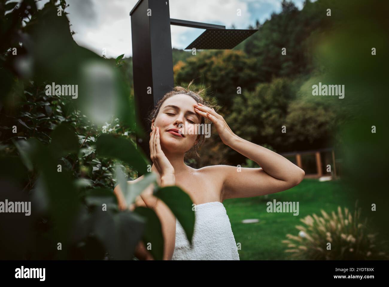 Beautiful woman resting in garden after using home sauna. Woman taking ...