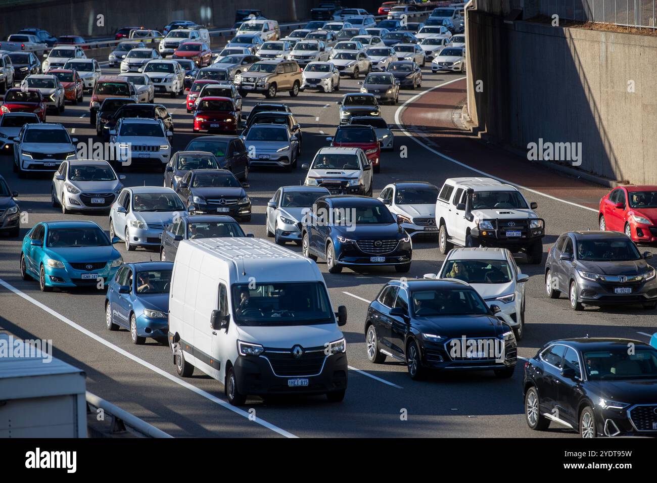 Heavy traffic on a multi-lane freeway in Perth, with a variety of ...