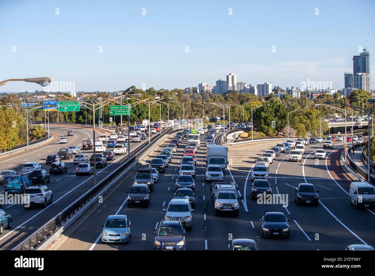 A busy freeway in Perth, Australia, filled with vehicles in afternoon ...
