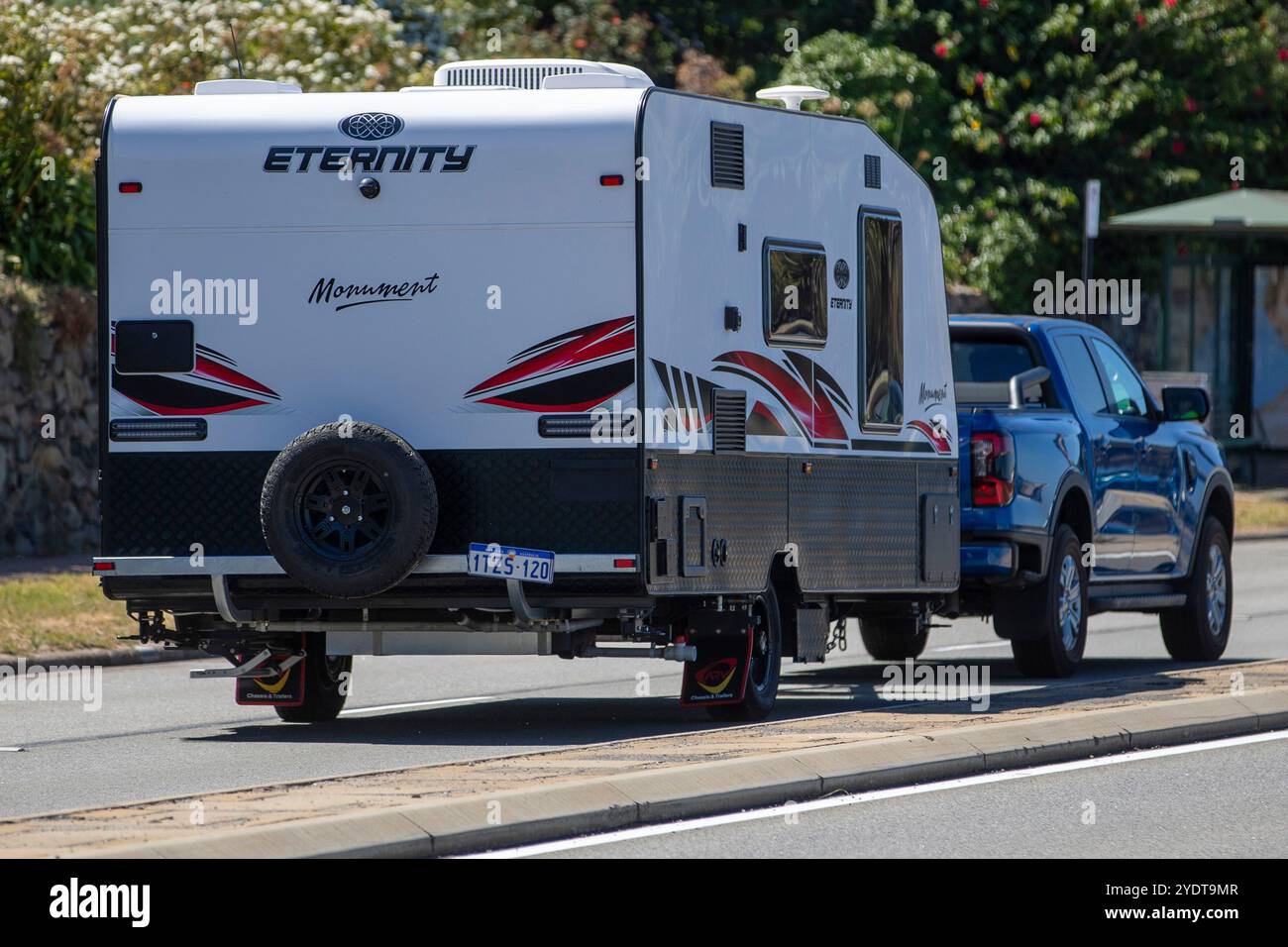 A metallic blue Ford Ranger towing a large white Eternity Monument ...
