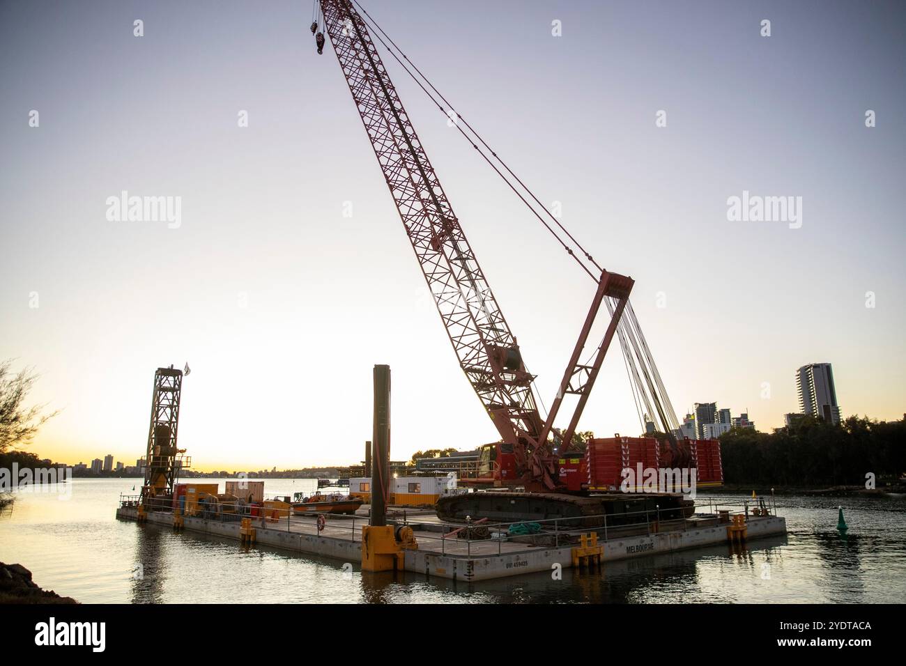 A large construction crane on a floating barge in the Swan River in Perth, Australia, during ...