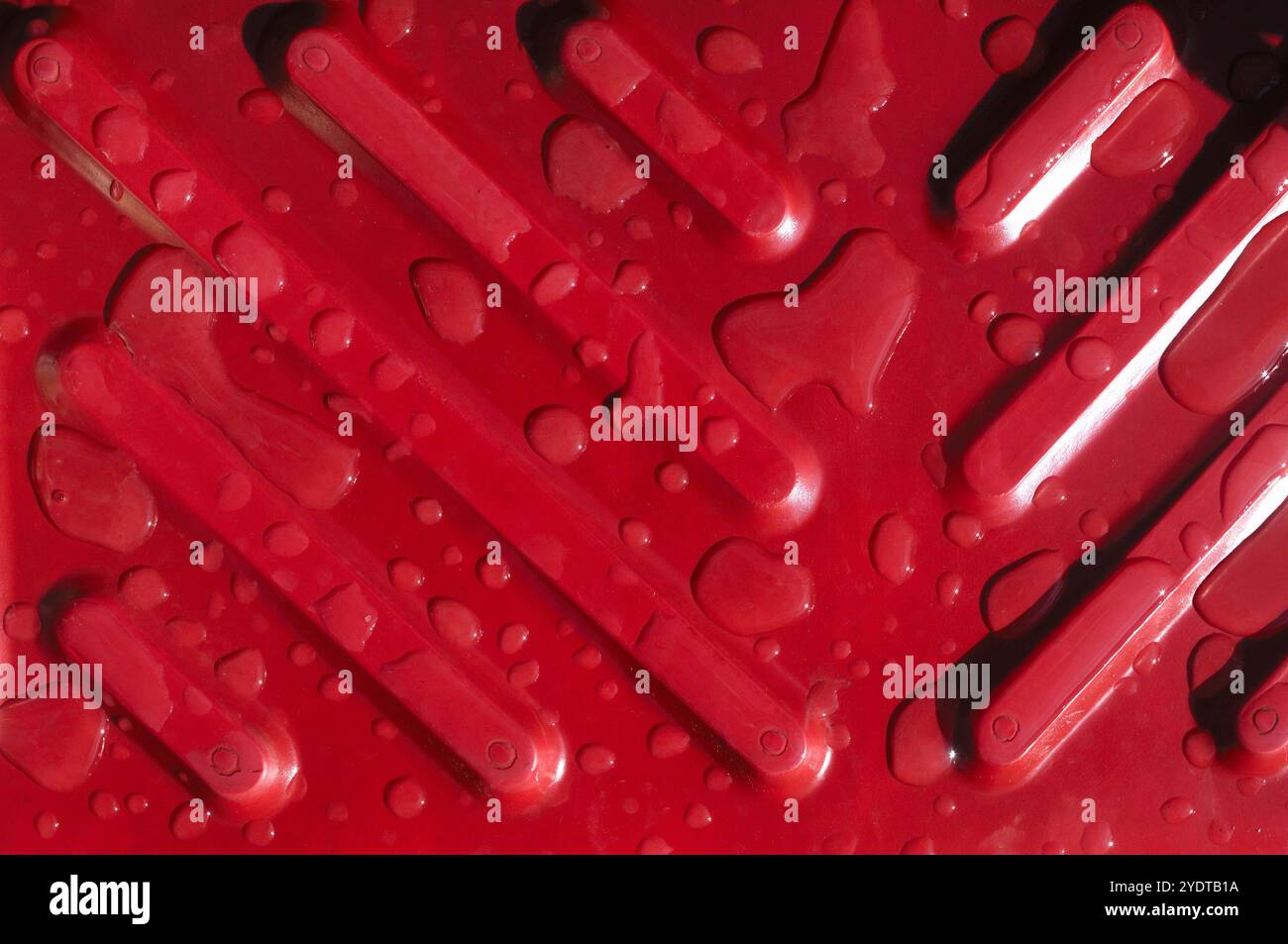 Water droplets on a red iron plate Stock Photo - Alamy