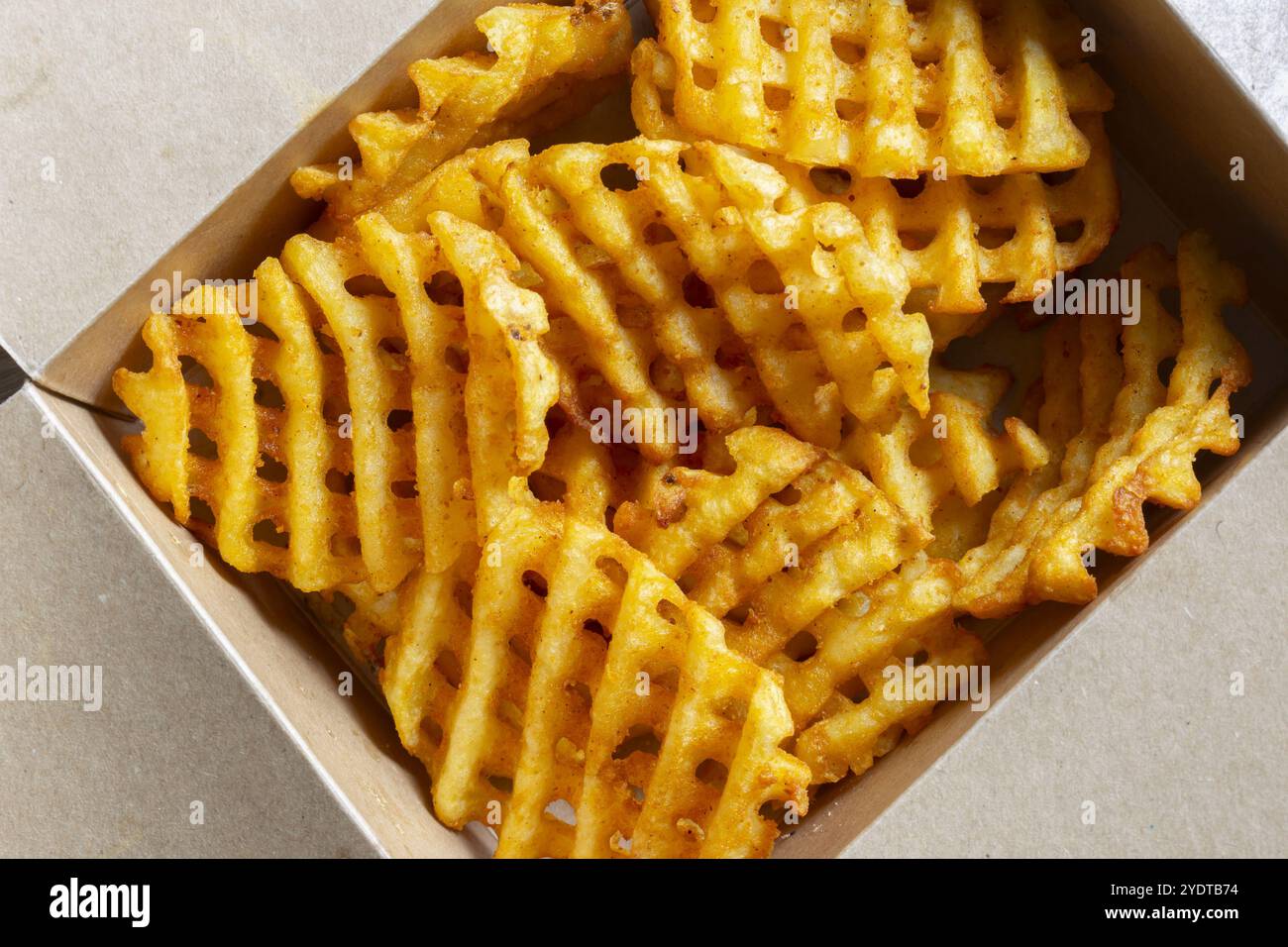 Waffle criss cross fries takeaway in a cardboard box. Biodegradable ...