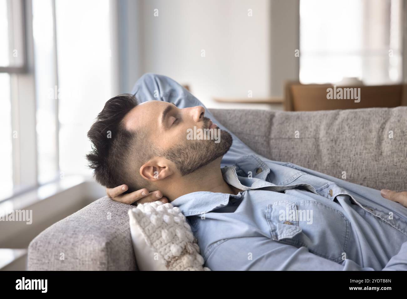 Calm sleepy handsome Hispanic man lying on soft comfortable couch Stock ...