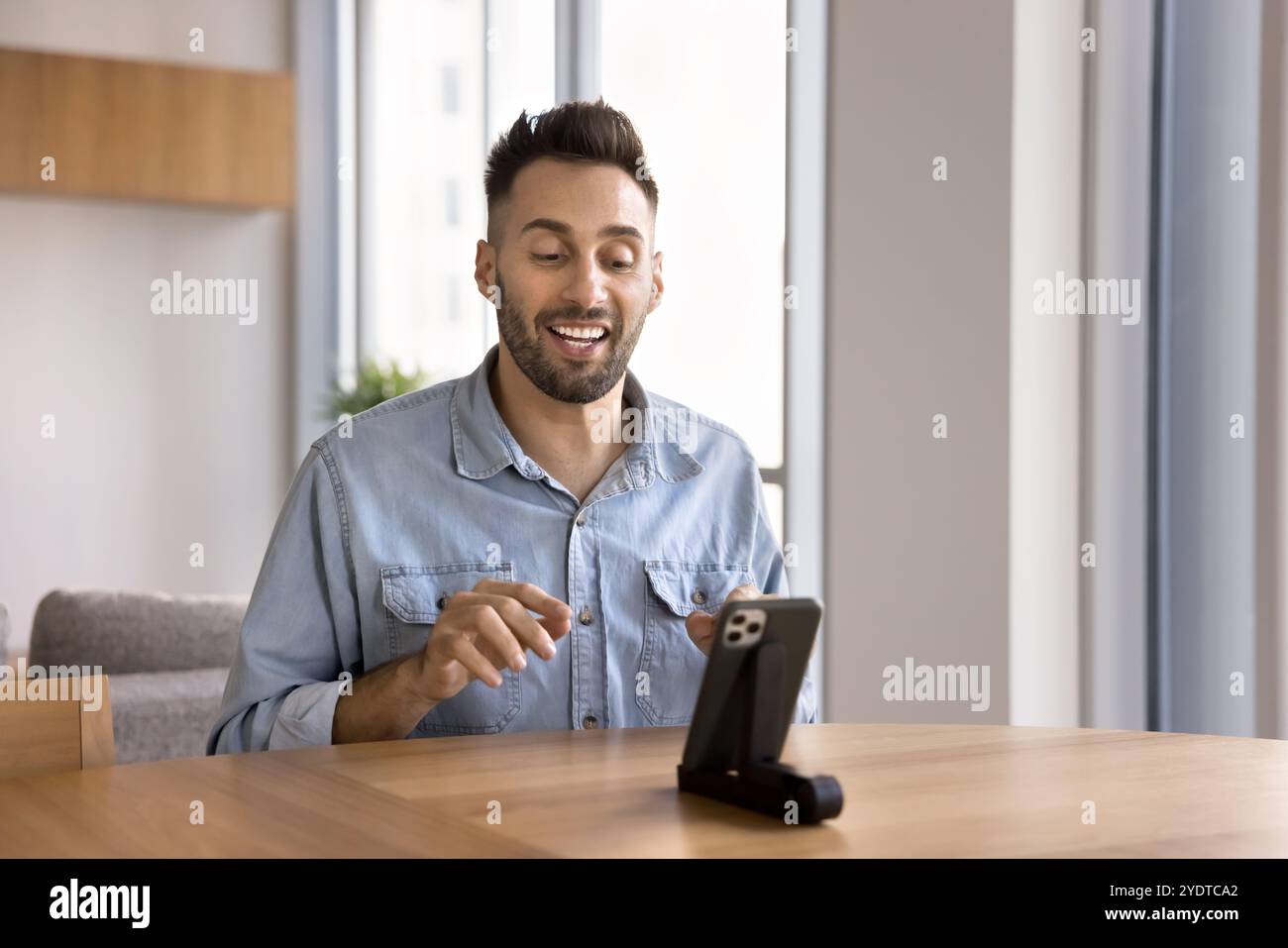 Happy Hispanic influencer man speaking at mobile phone web camera Stock ...