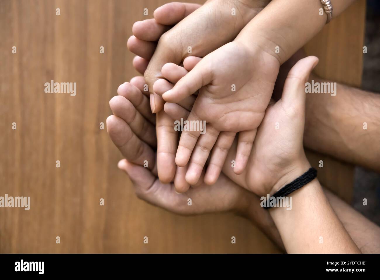 Stacked open palms of parents and little kids top view Stock Photo - Alamy