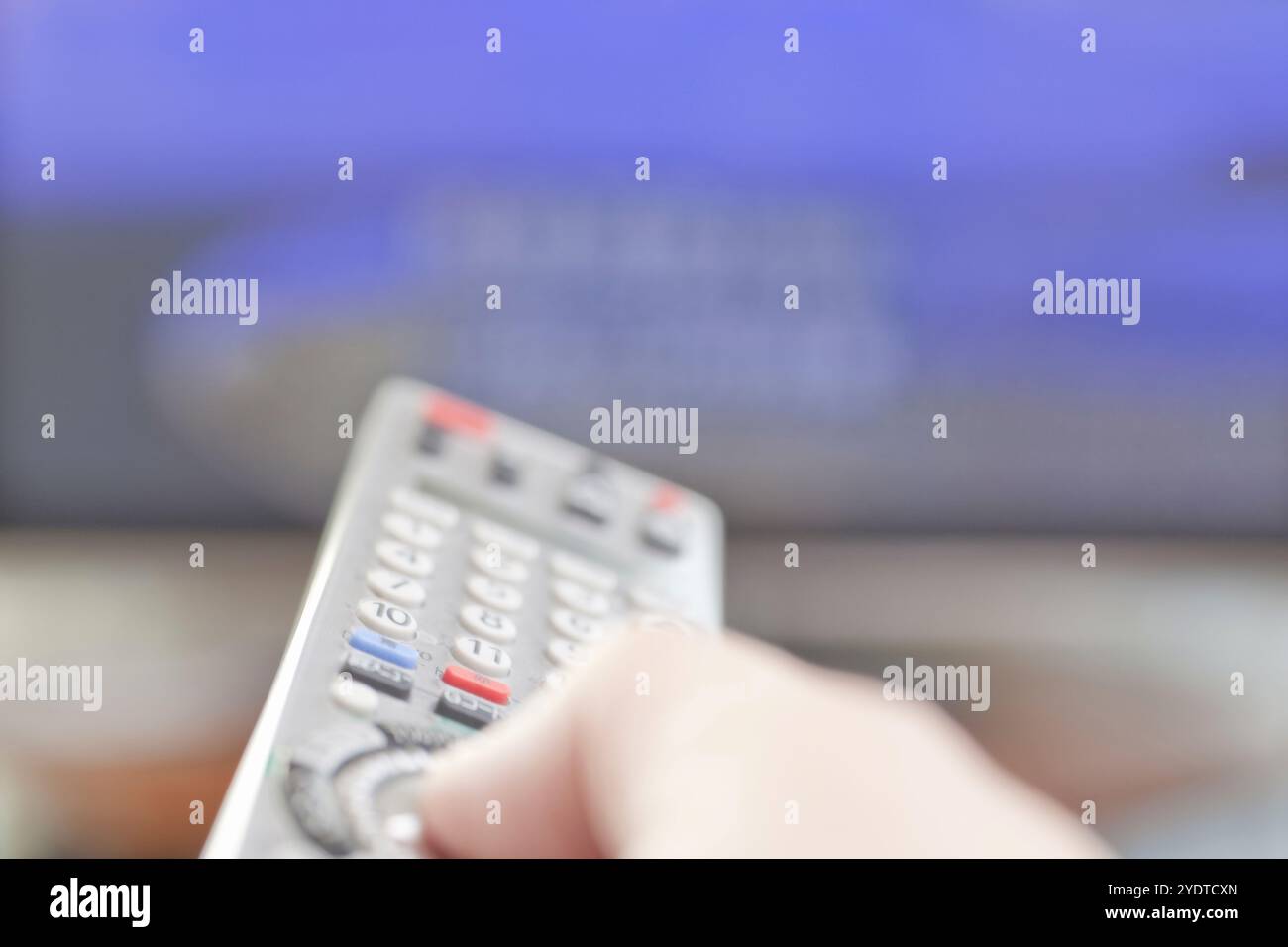 Operating the TV remote control Stock Photo - Alamy