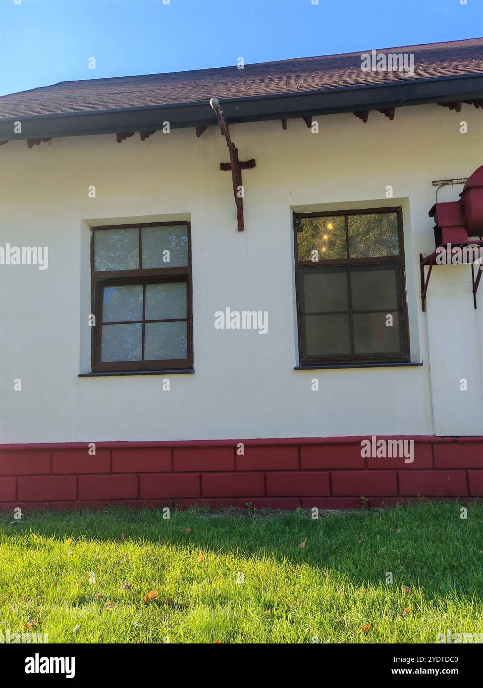 sturdy building with red brick columns and a sloping roof, set against ...