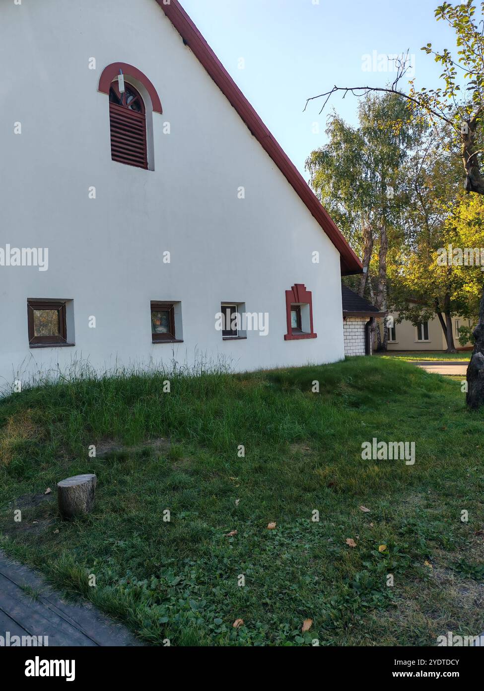 An old building with striking red brick pillars and a pitched roof ...