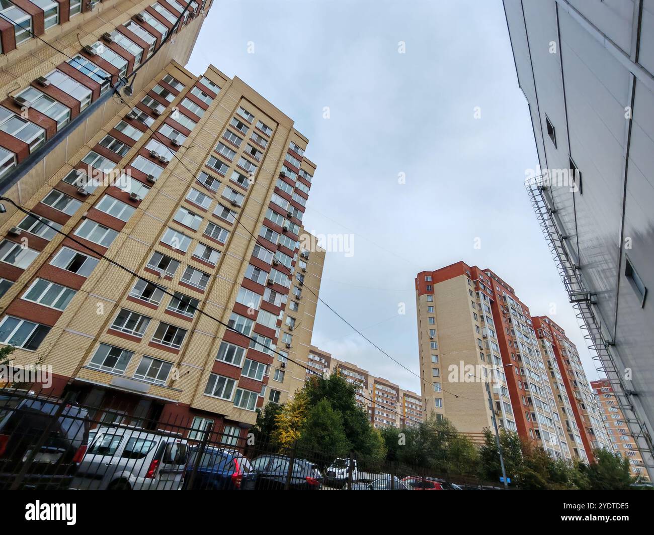 A pastel-colored high-rise residential building with curved balconies ...