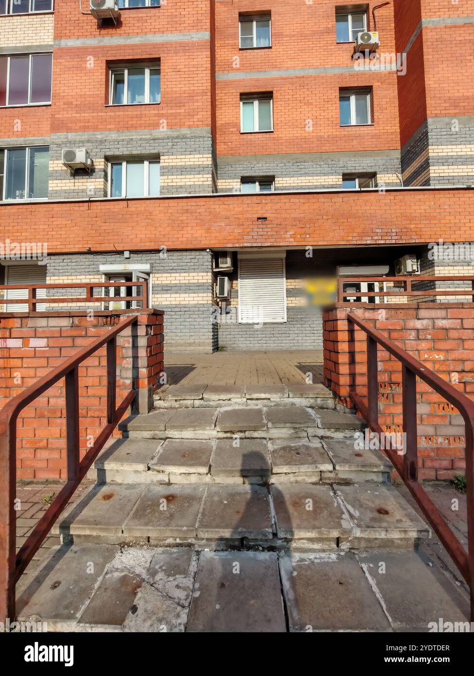A close-up of a red and gray brick building facade, featuring windows ...