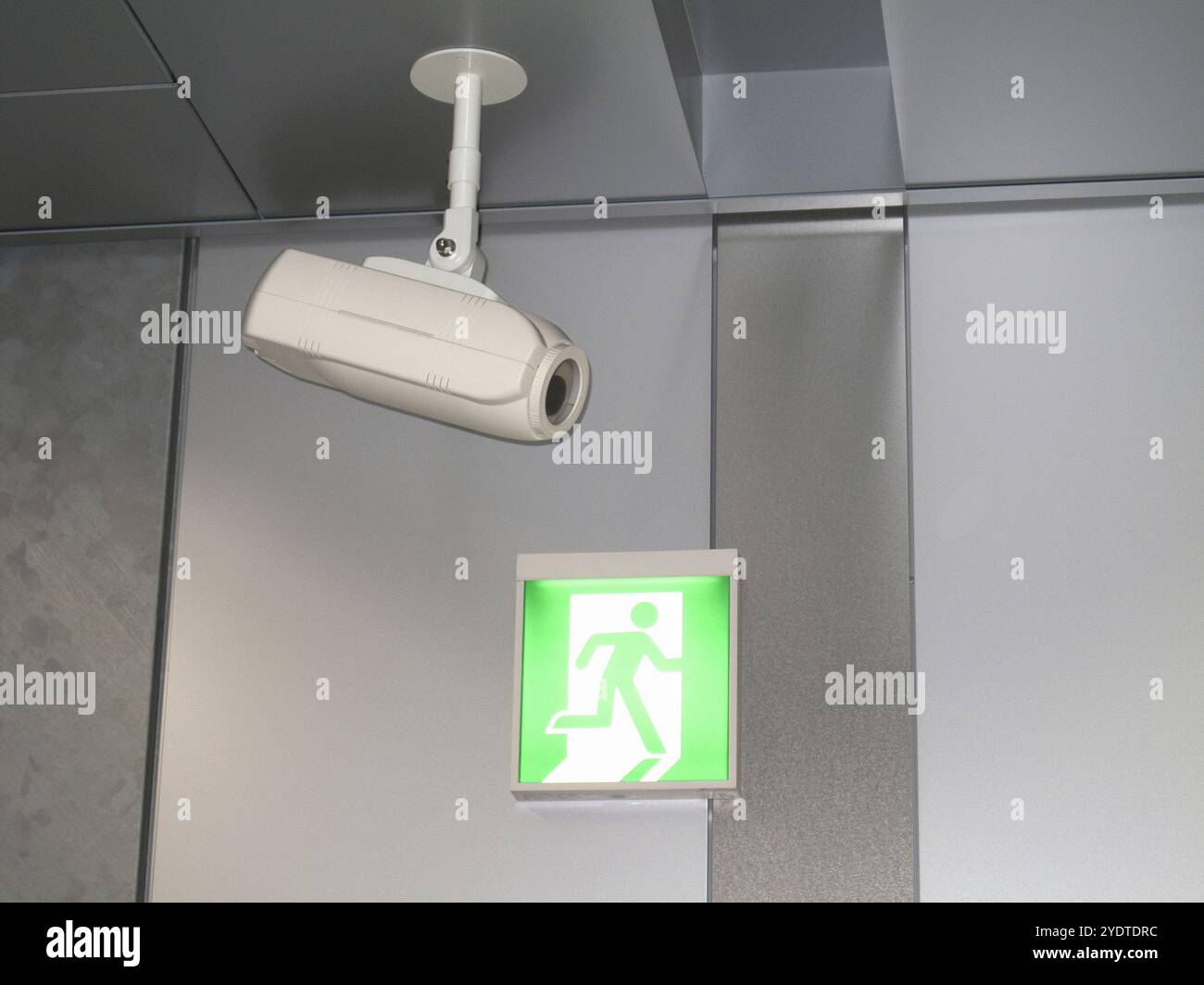 Security camera and emergency exit sign Stock Photo - Alamy