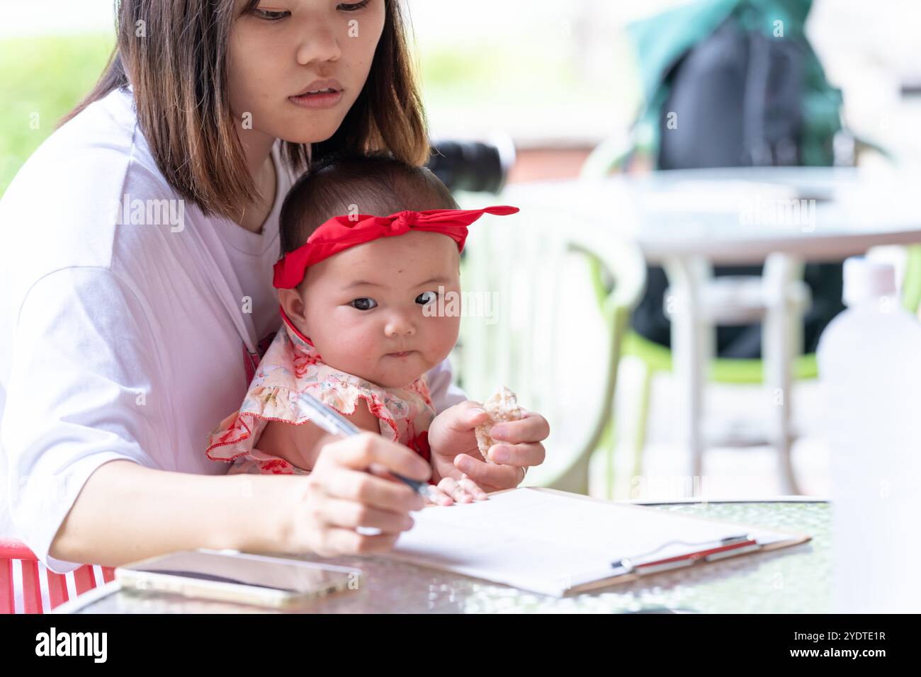 A Taiwanese couple in their 20s and their 7-month-old baby celebrate a ...