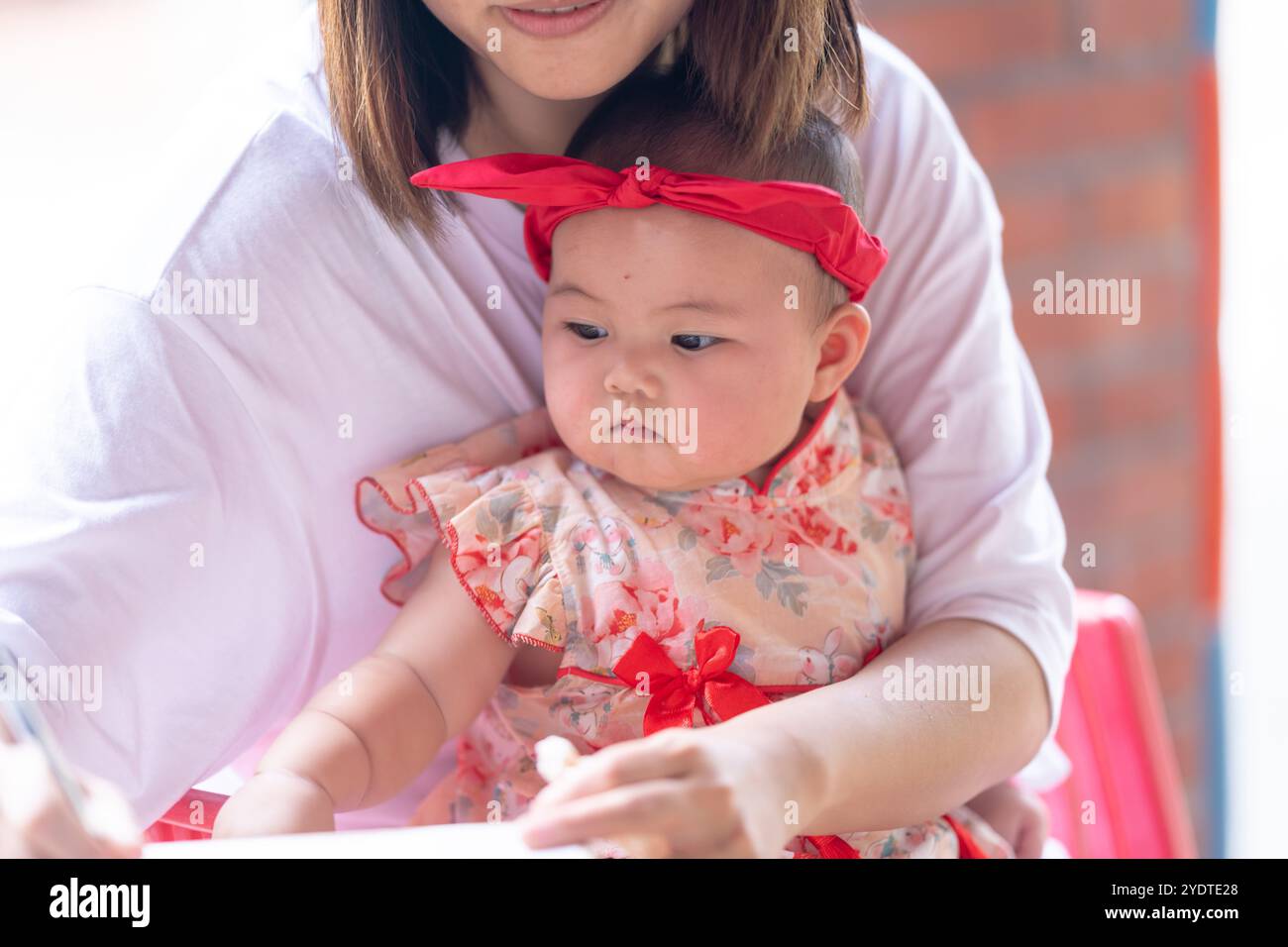A Taiwanese couple in their 20s and their 7-month-old baby celebrate a ...