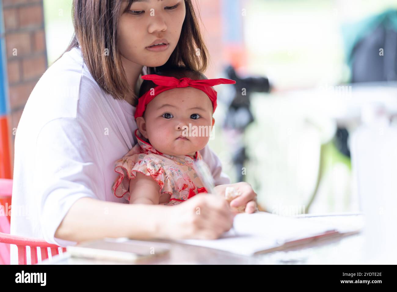 A Taiwanese couple in their 20s and their 7-month-old baby celebrate a ...