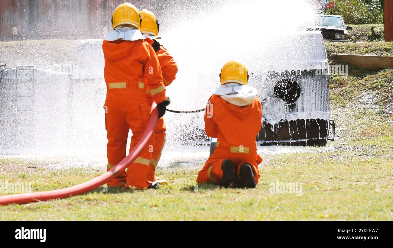 Firefighter fighting with flame using fire hose chemical water foam ...