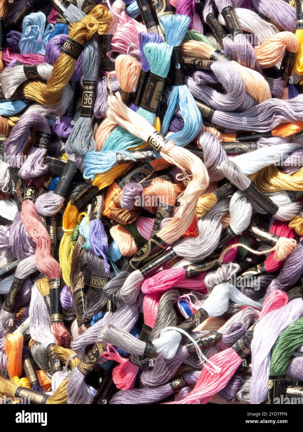 Piles of colourful threads Stock Photo - Alamy