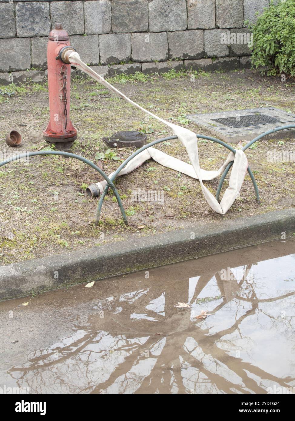Fire hydrant with hose connected Stock Photo - Alamy