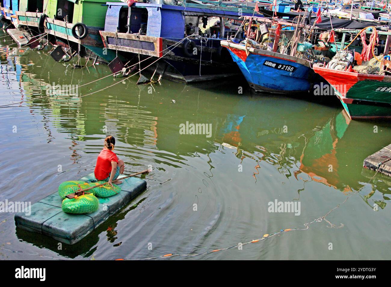 Fishing vessels anchor at a harbor to avoid approaching Typhoon Trami ...