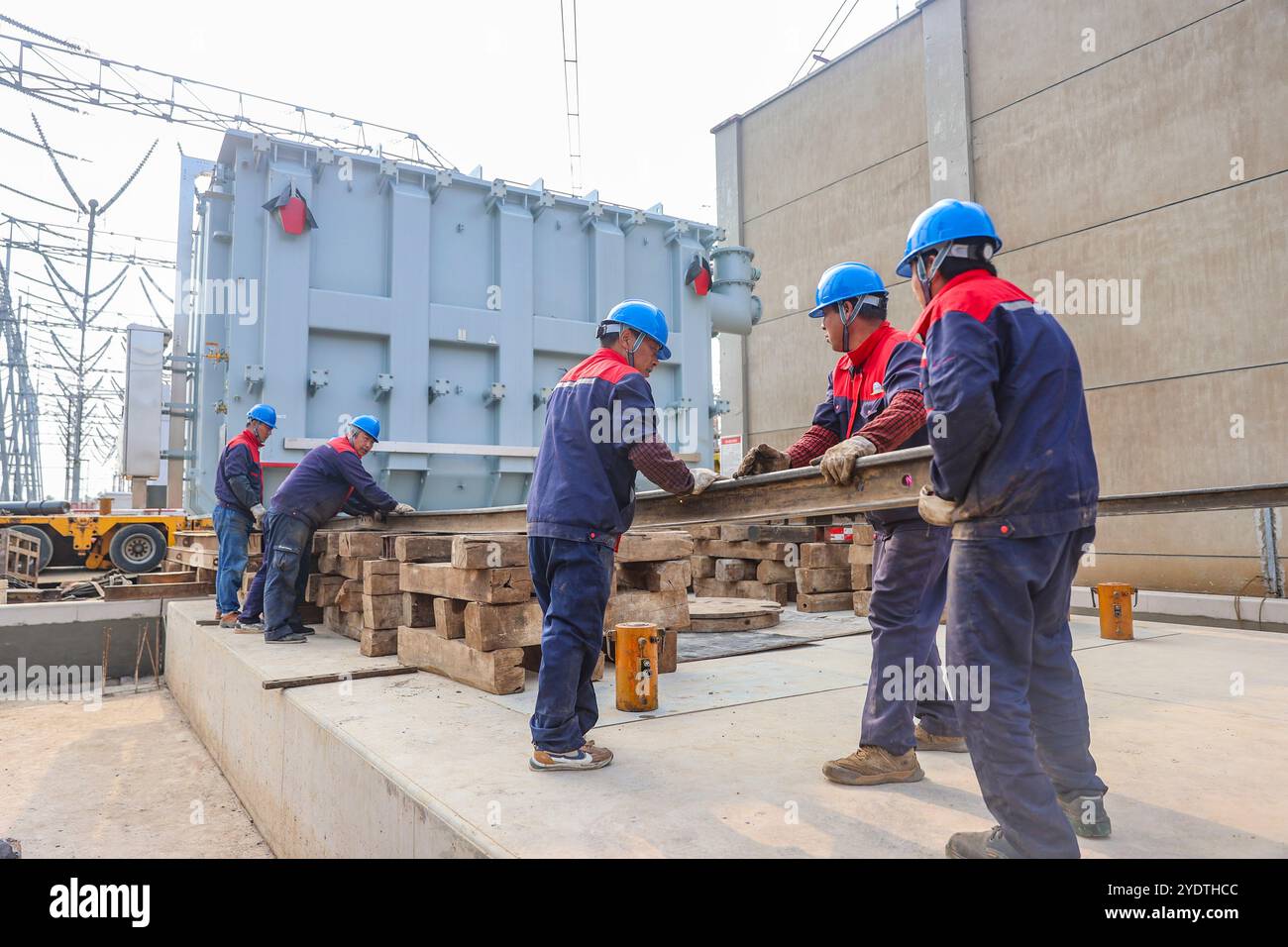ZHENJIANG, CHINA - OCTOBER 28, 2024 - Power workers move a main ...