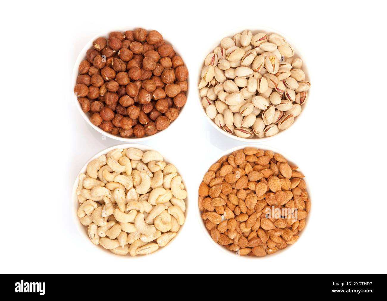 Variety of nuts in bowls over white background Stock Photo - Alamy